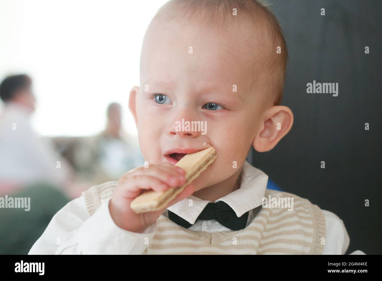One year old baby boy eating waffer Stock Photo - Alamy