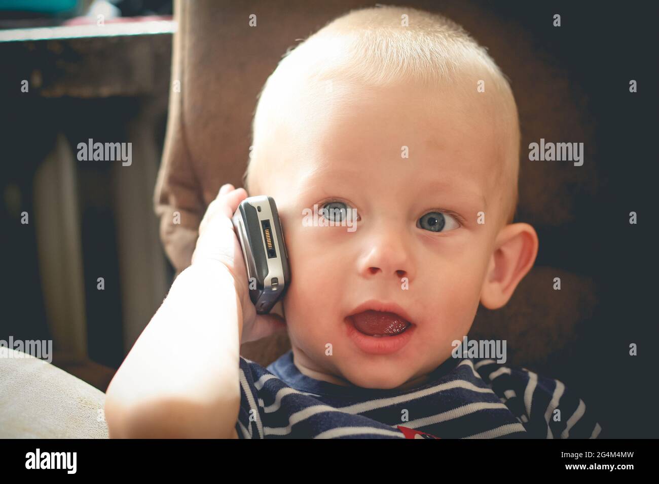 One year old baby boy calling a cell phone Stock Photo - Alamy