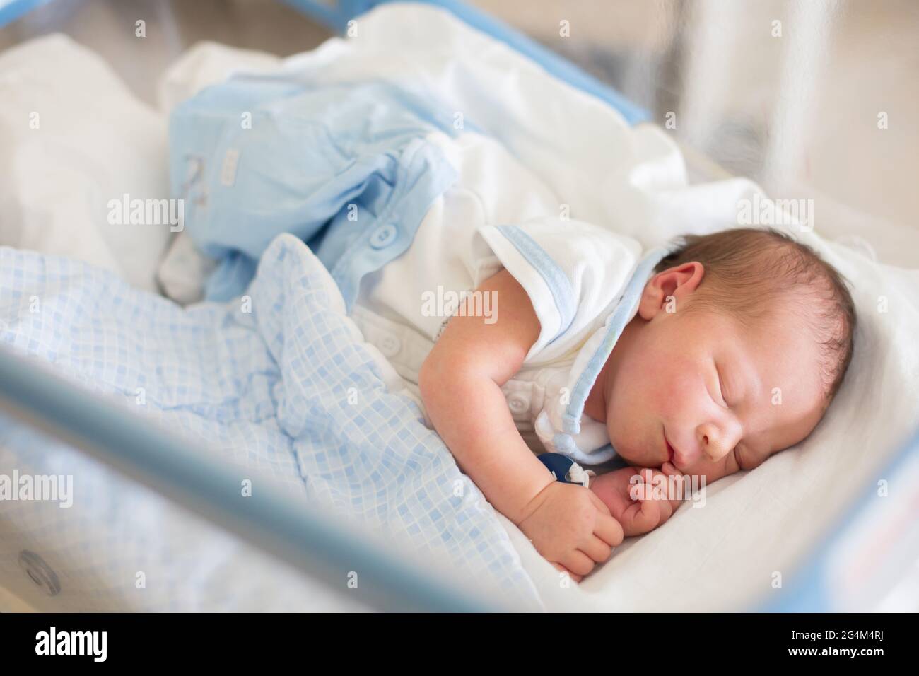 Beautiful newborn baby boy, laying in crib in prenatal hospital Stock Photo - Alamy