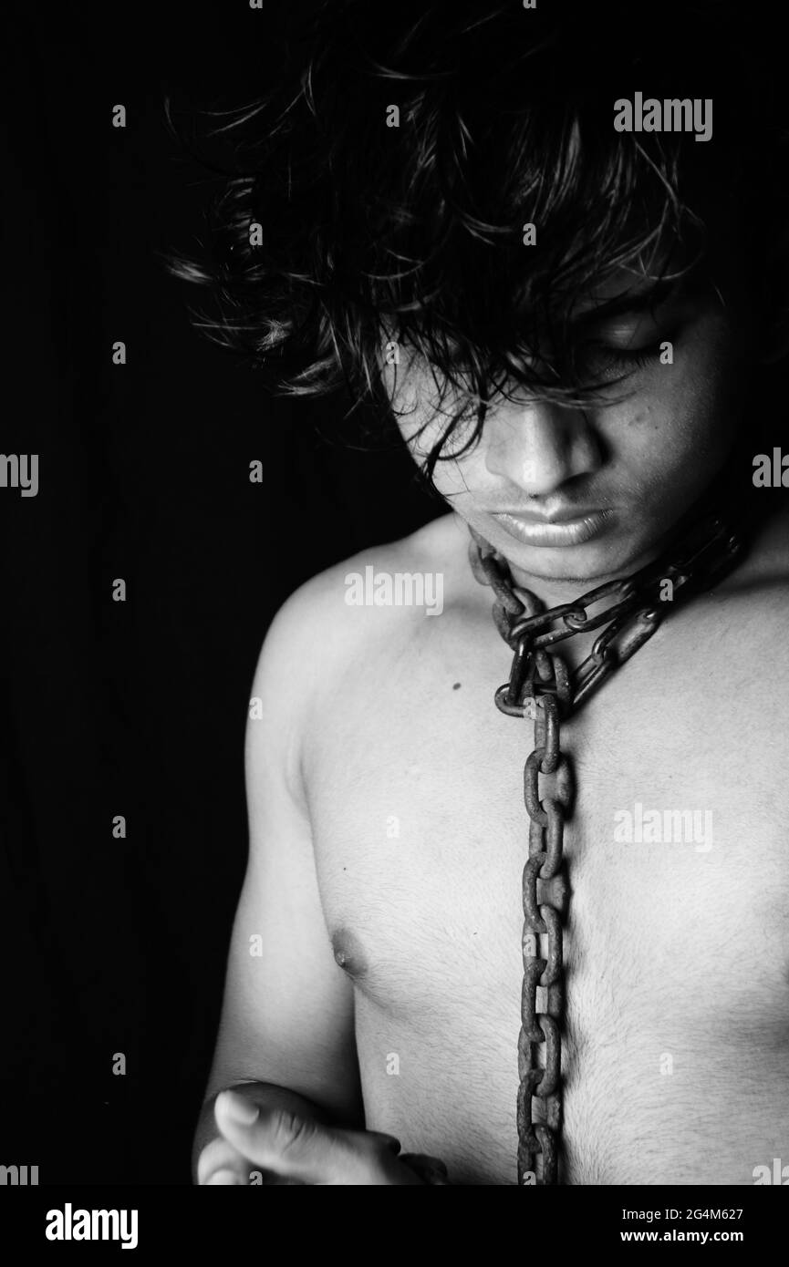 Grayscale shot of a chained up guy Stock Photo - Alamy