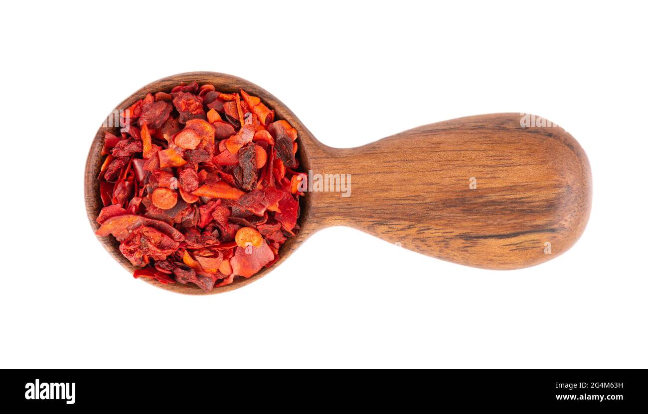 Dried red chili flakes in wooden spoon, isolated on white background ...