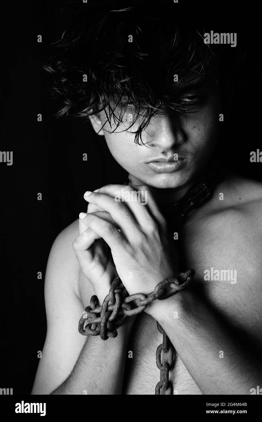 Grayscale shot of a chained up guy Stock Photo - Alamy