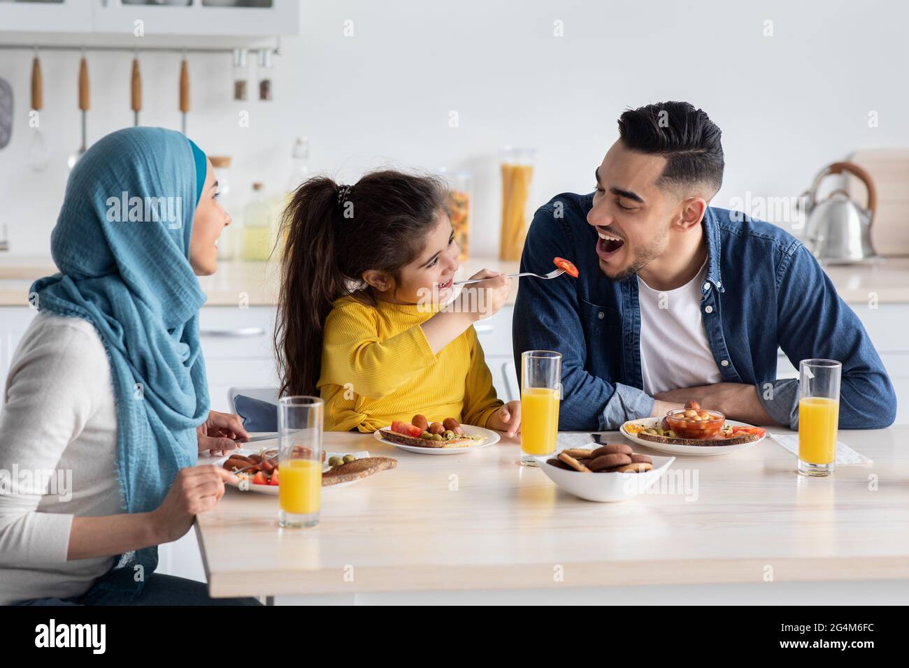 Breakfast Time. Happy Muslim Family Of Three Having Morning Meal In ...