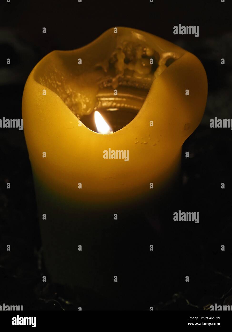Lit Yellow green candle Stock Photo - Alamy