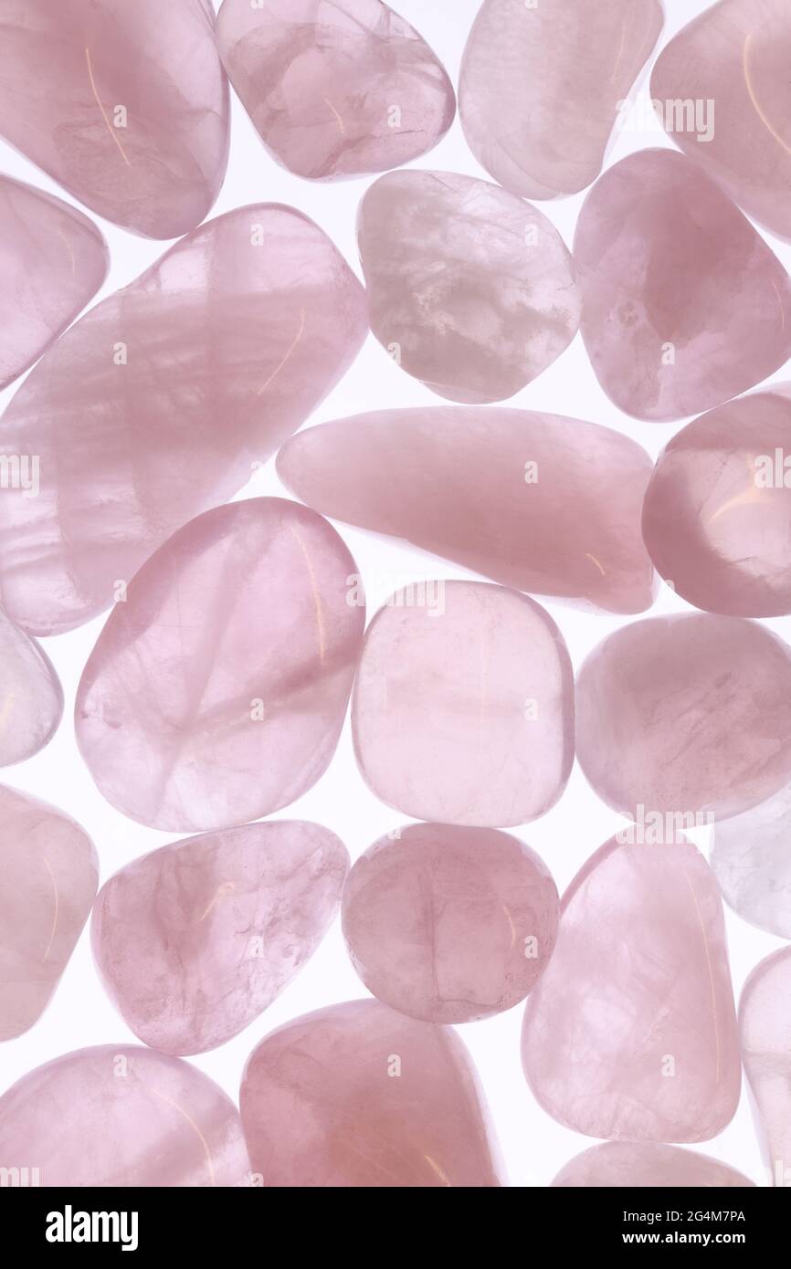 Rose quartz jewel heap texture on light surface. Mineral pebbles ...