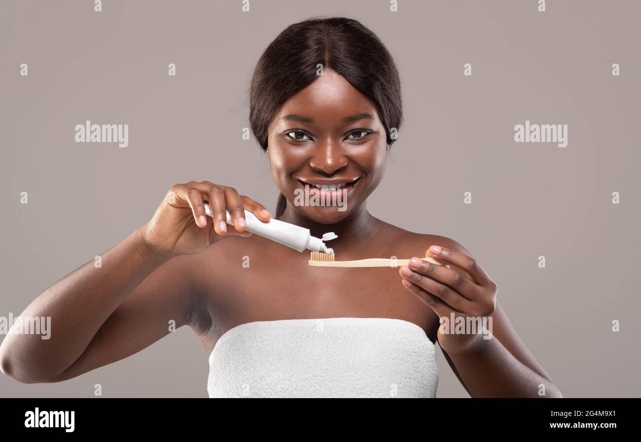 Oral Hygiene. Beautiful Black Woman Applying Toothpaste On Eco Bamboo ...