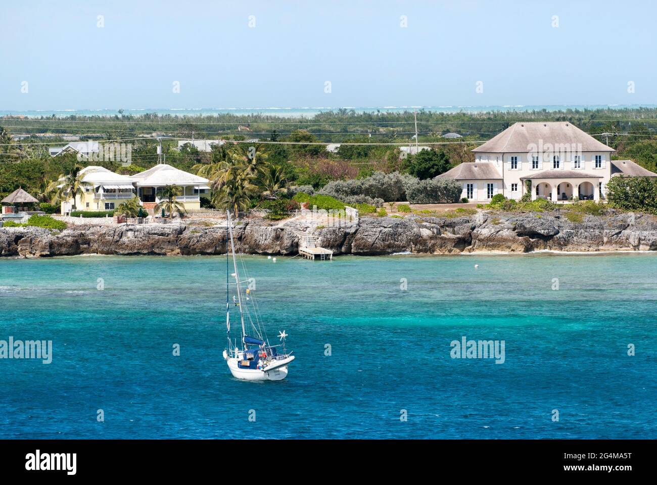 The view of a drifting yacht near Grand Cayman island with residential ...