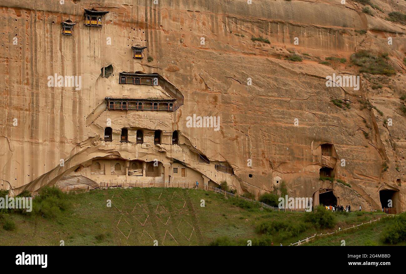Wangye, China. 22nd June, 2021. Tourists visit the Temple Grottoes near ...
