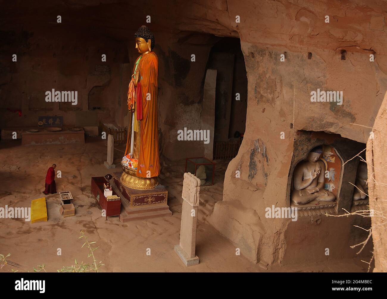 Wangye, China. 22nd June, 2021. A Buddhist monk cares for a cave full ...