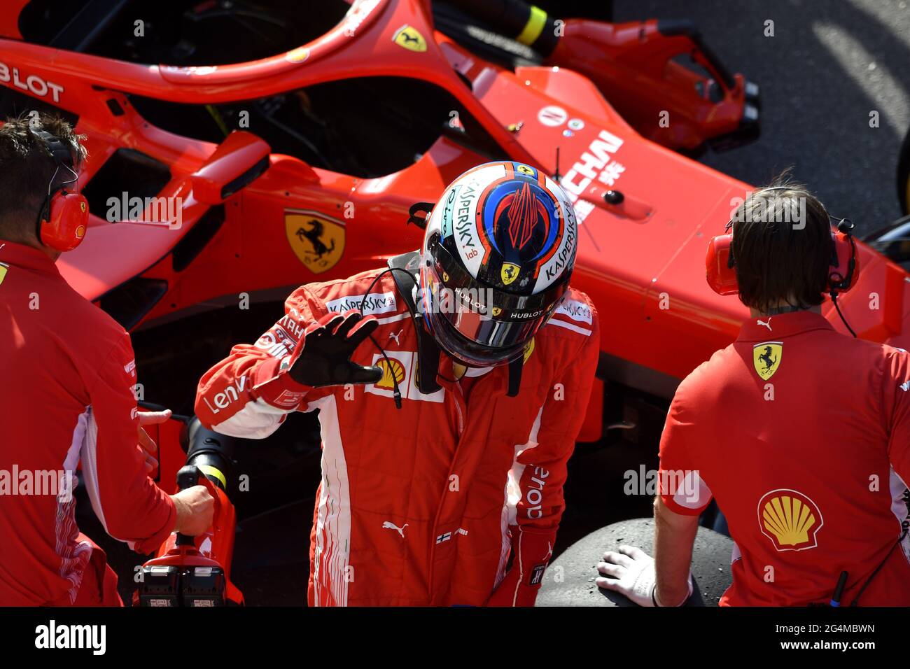 Ferrari's pit stop crew working around the Ferrari Formula One at the ...