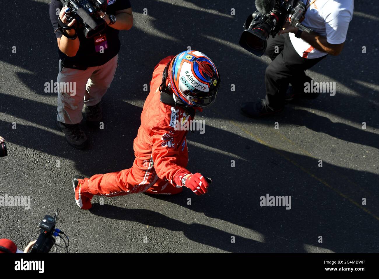 Ferrari's pit stop crew working around the Ferrari Formula One at the ...