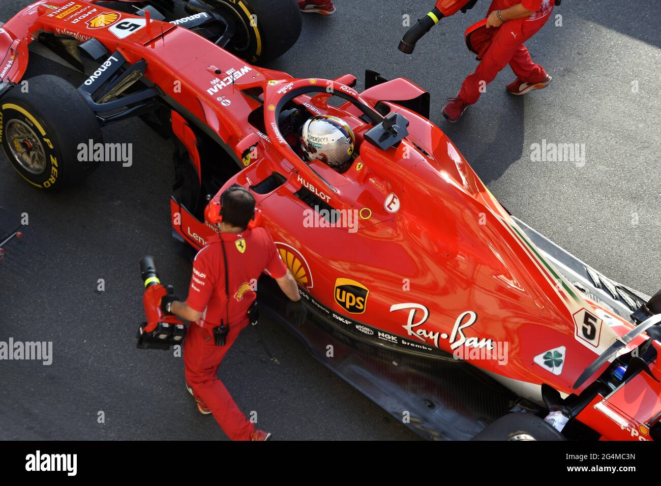 Ferrari's pit stop crew working around the Ferrari Formula One at the ...