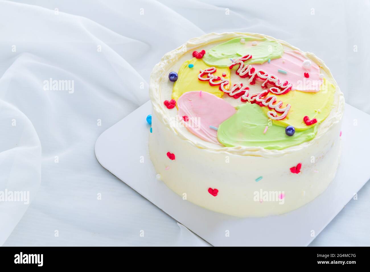 Pastel color butter cream cake on white cloth background, Happy birth ...