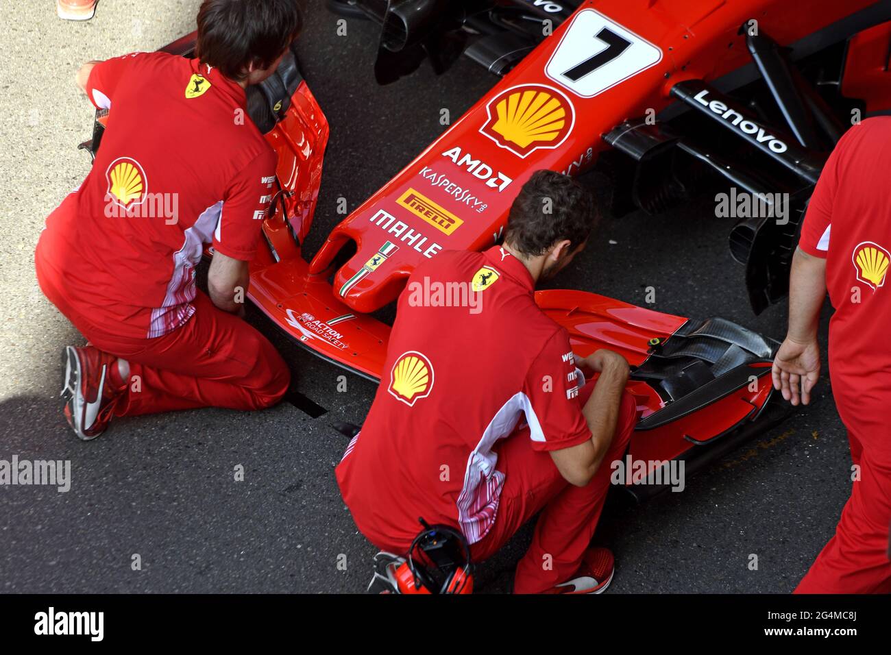 Ferrari's pit stop crew working around the Ferrari Formula One at the ...