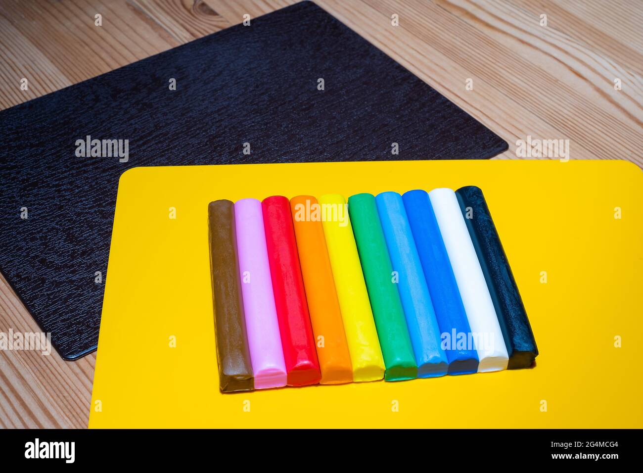 Colored plasticine on yellow board Stock Photo - Alamy