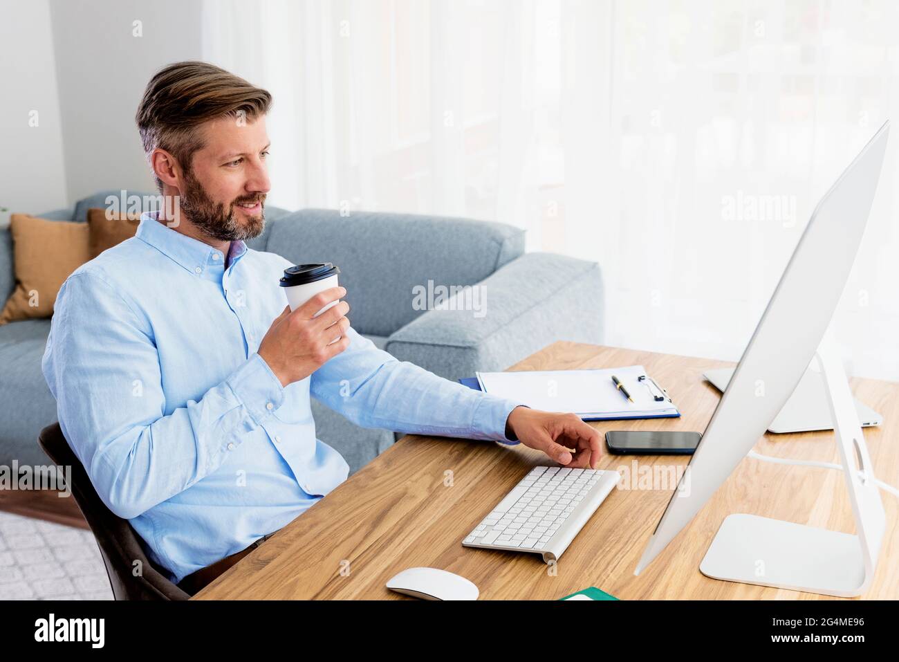 Shot of businessman sitting behind his computer and having discussion ...