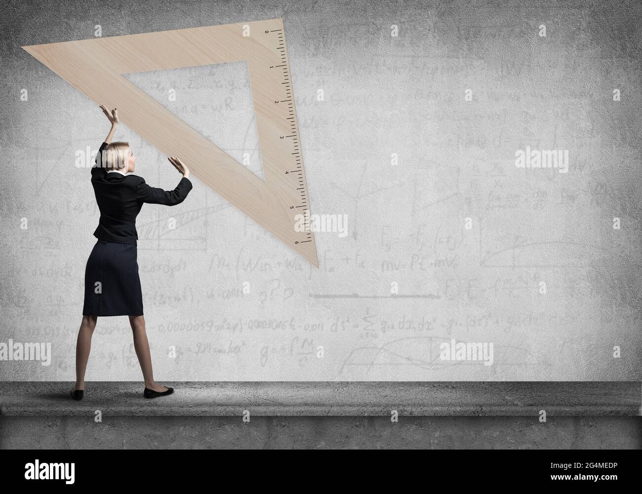 Woman in business suit holding big ruler Stock Photo - Alamy