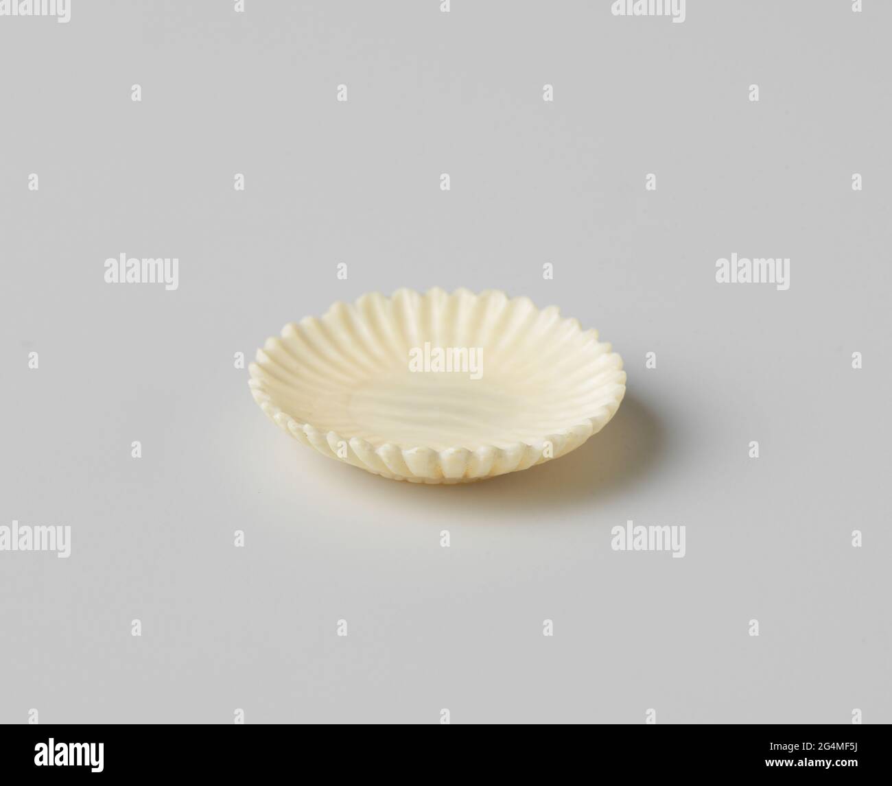 Dish with scalloped edge. Dish of ivory, with scalloped edge Stock ...