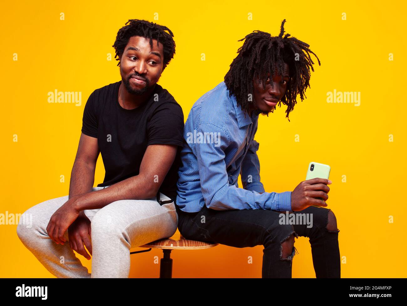 two african american guys posing cheerful together on yellow background ...