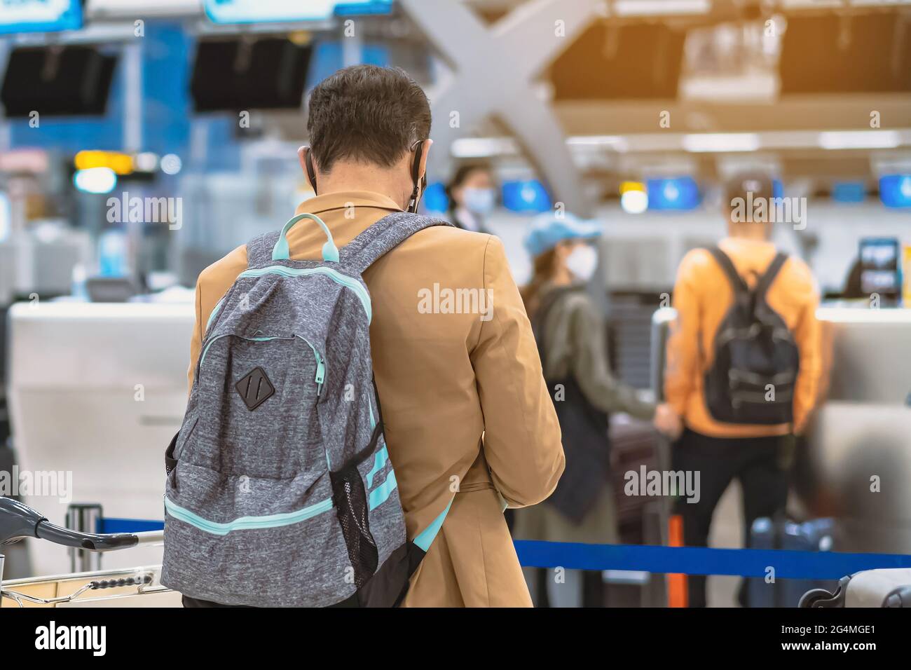 Back view of airline passenger wear face mask to prevent Corona virus ...