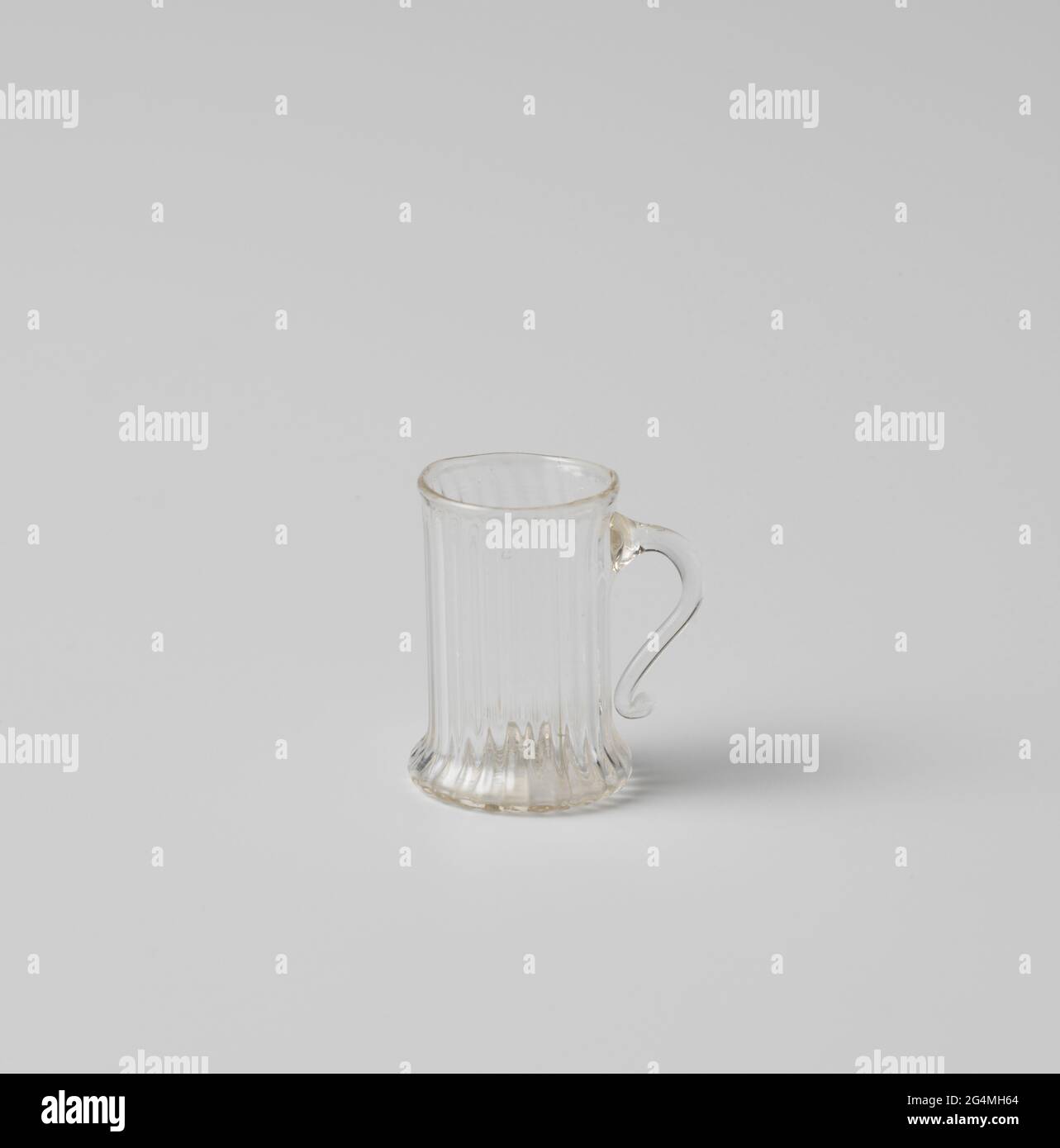 Cup with ear, body cylindrical with vertical ridges. Cup of bright ...