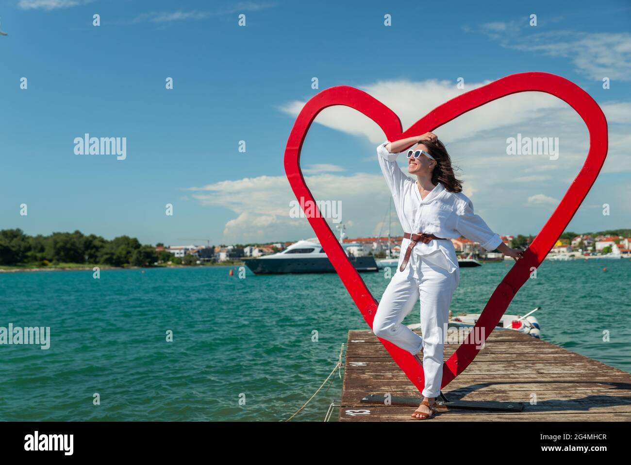 woman near heart shape photo spot at sea beach. Croatia Istria Stock ...