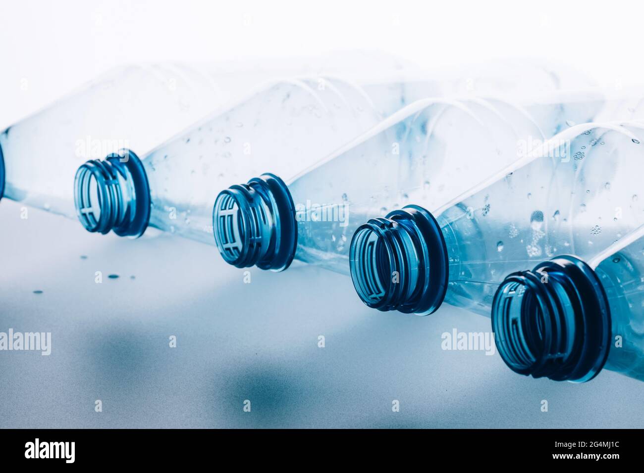 Used transparent plastic bottles on light blue background. Group of ...