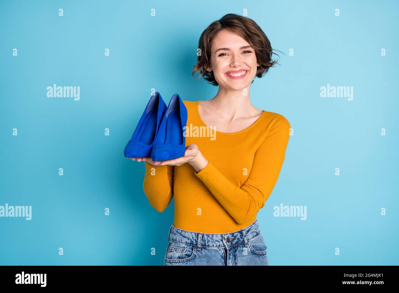 Portrait Of Optimistic Nice Brunette Short Hairdo Lady Hold Shoes Wear