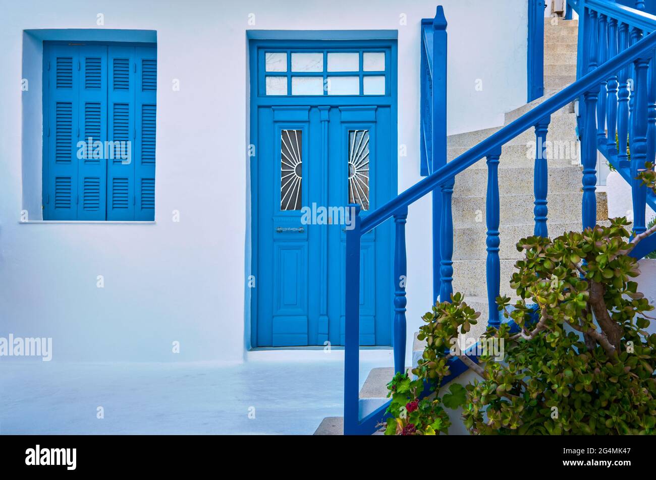 Traditional Greek porch, whitewashed walls, blue shutters, doorway and ...