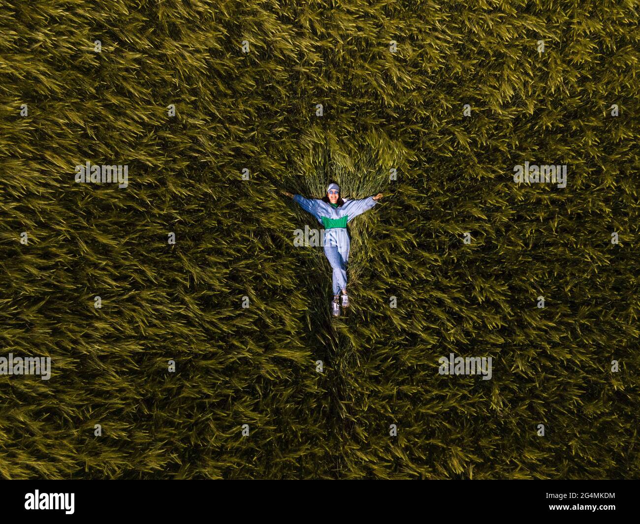smiling woman laying down in wheat field overhead top view Stock Photo ...