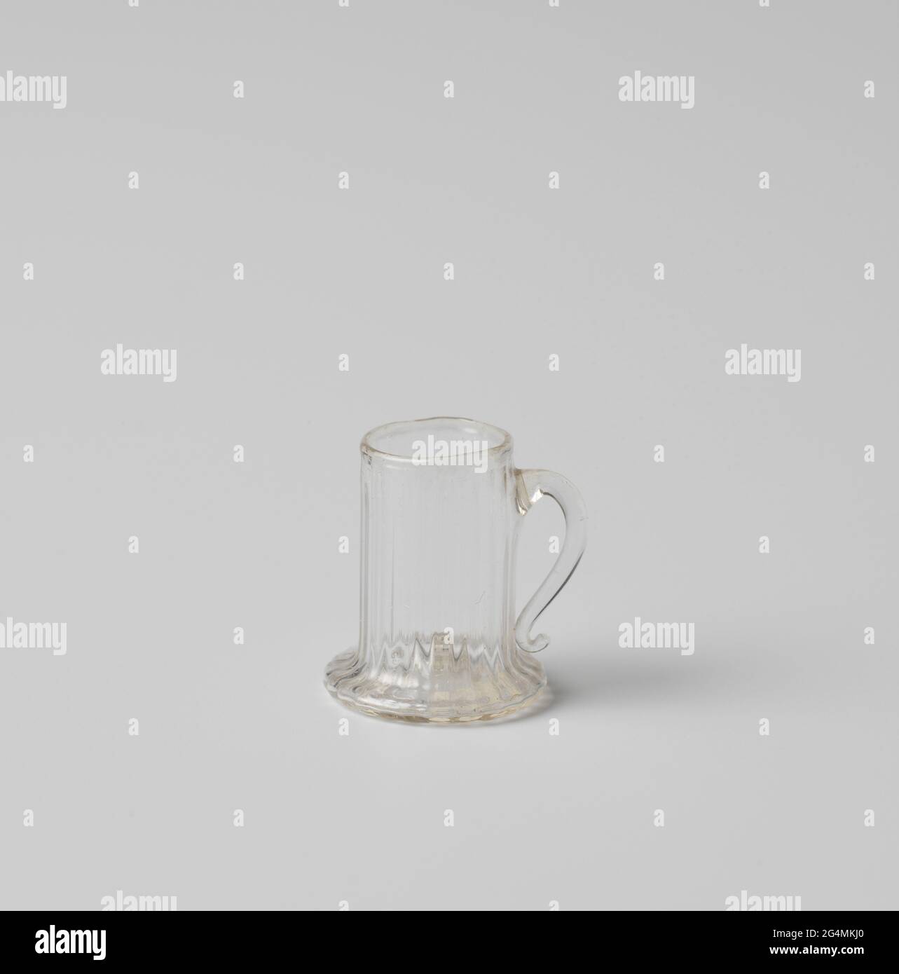 Cup with ear, body cylindrical with vertical ridges. Cup of bright ...