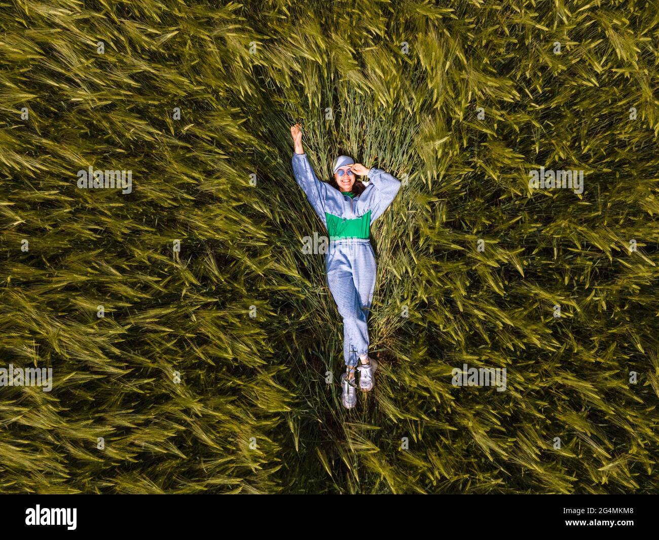 smiling woman laying down in wheat field overhead top view Stock Photo ...