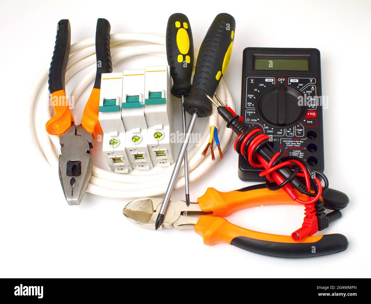 set of electrician tools and equipment and a coil of wire on a white ...
