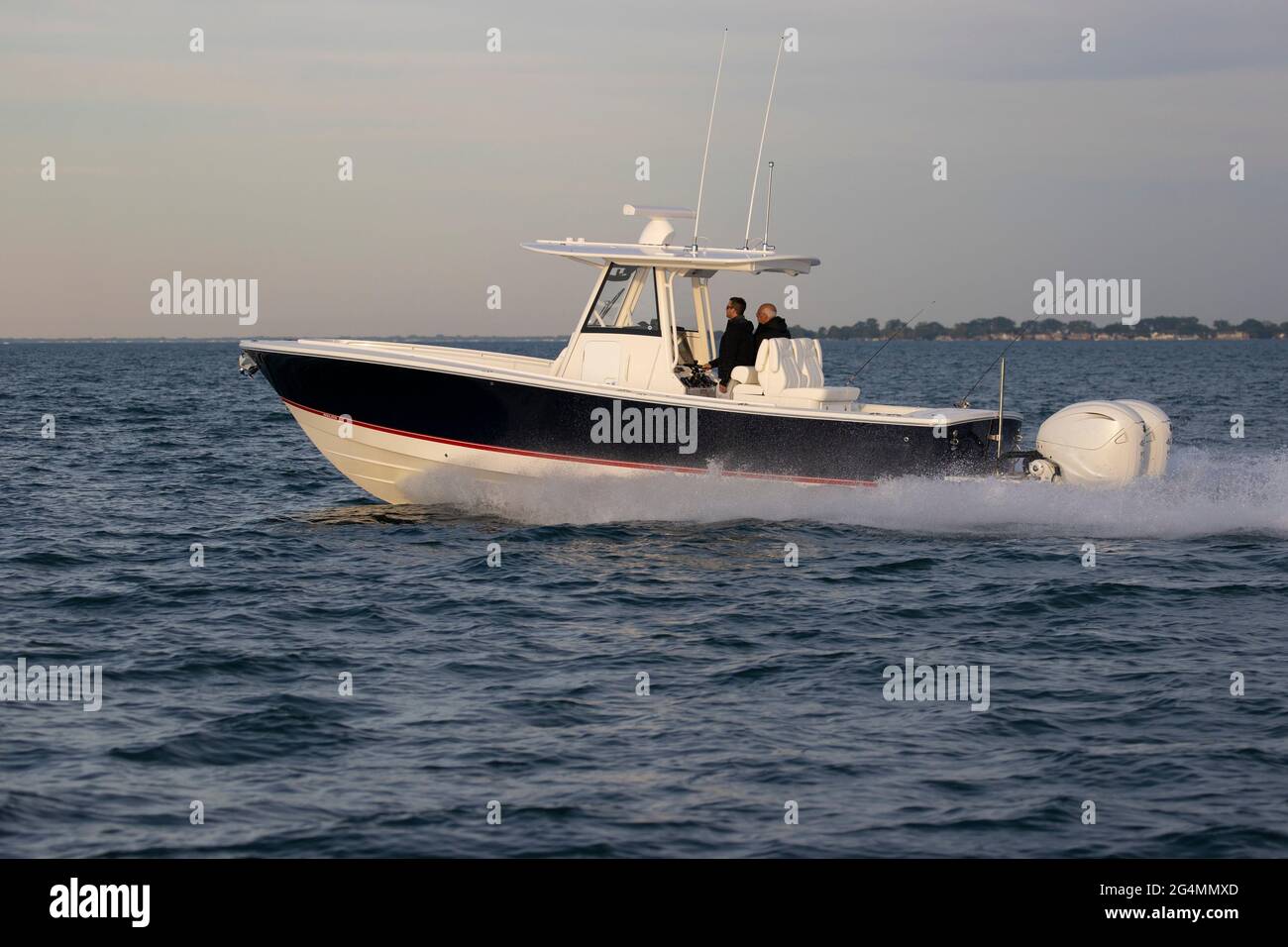 Side view of a center console boat cruising on a lake Stock Photo - Alamy