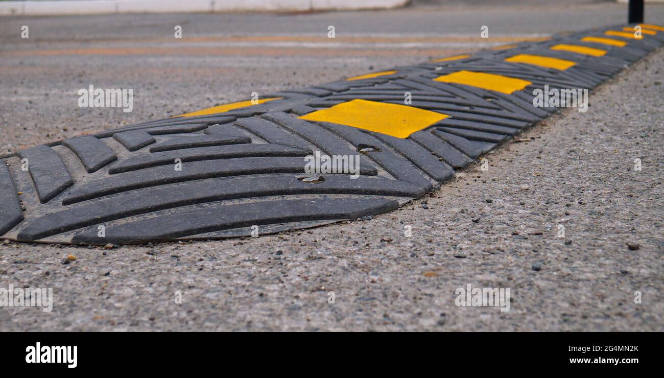 Bolted down speed bump made of rubber on asphalt road, closeup Stock ...