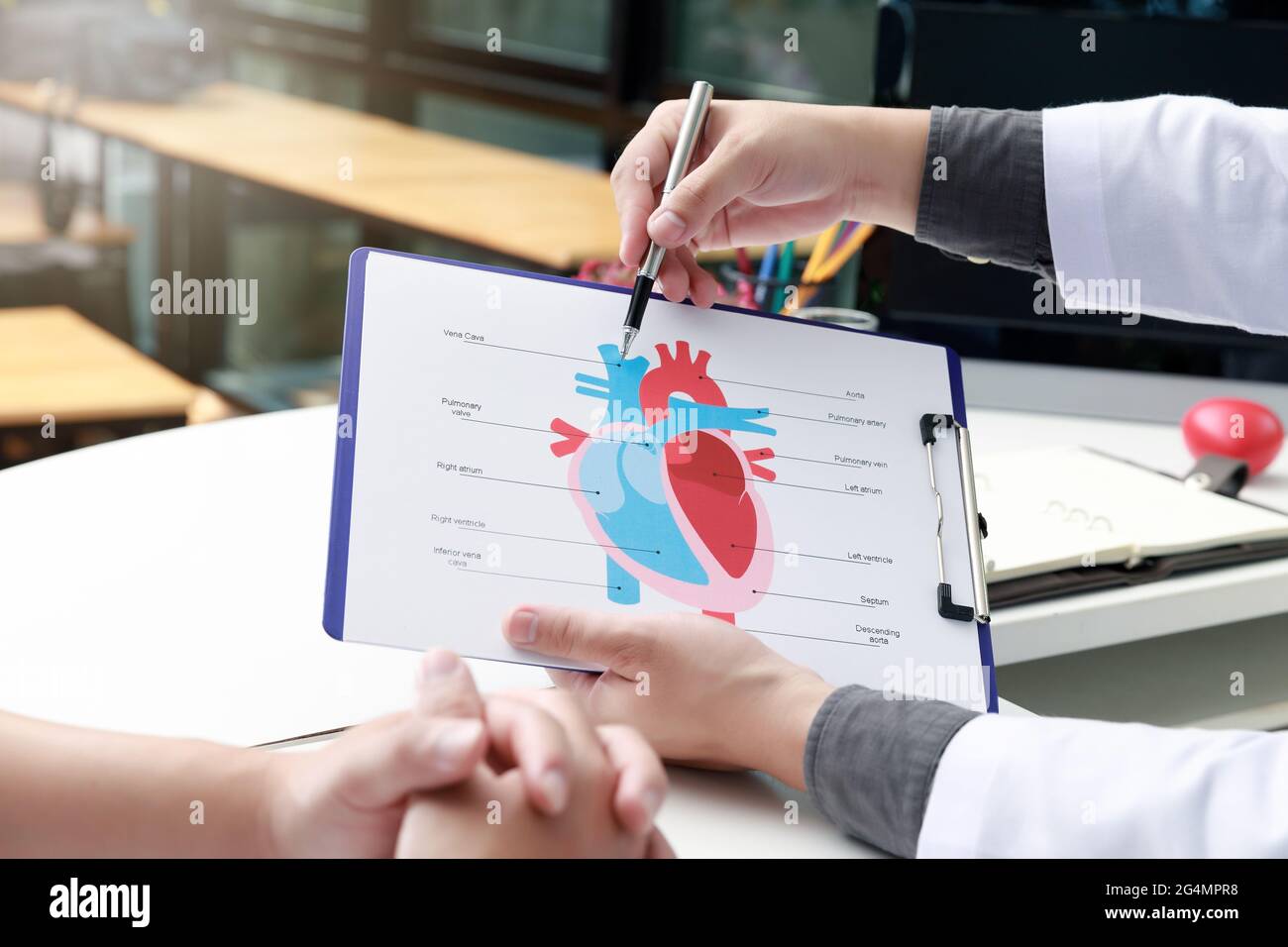Doctor explaining heart to patient about details and risks operation ...