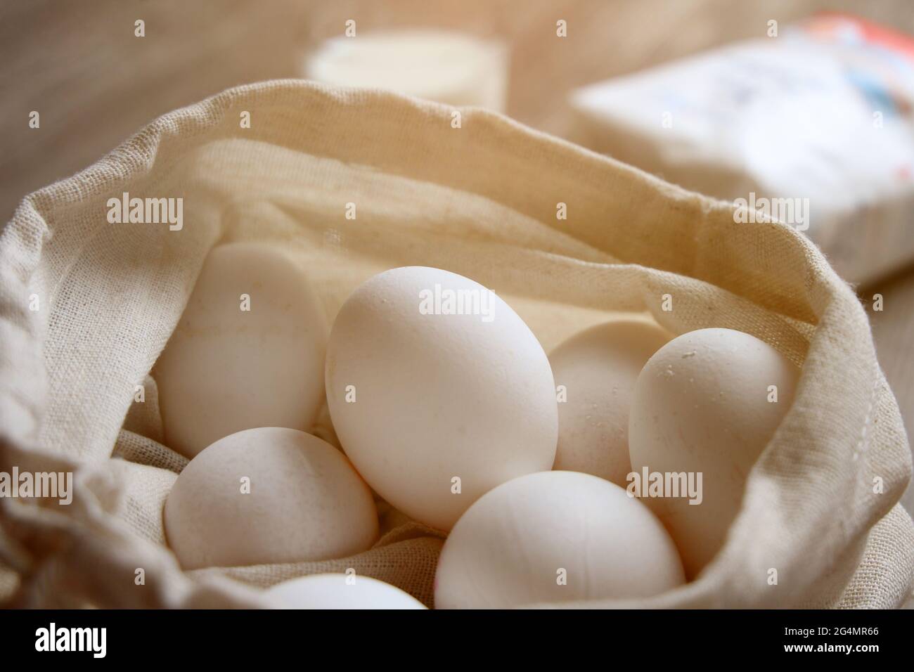 Symbolic image of baking ingredients: Eggs in a fabric bag Stock Photo ...