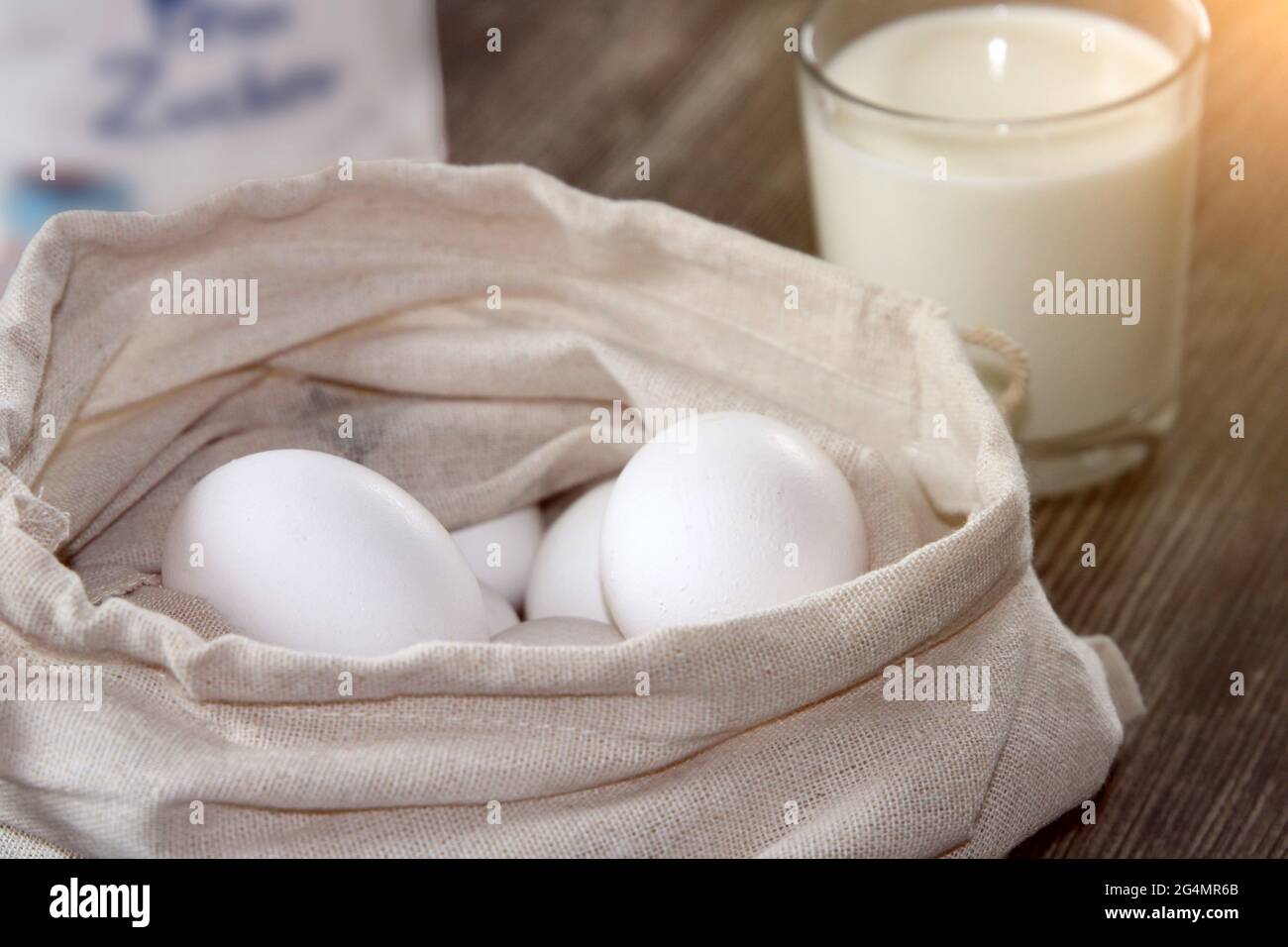 Symbolic image of baking ingredients: Eggs in a fabric bag Stock Photo ...