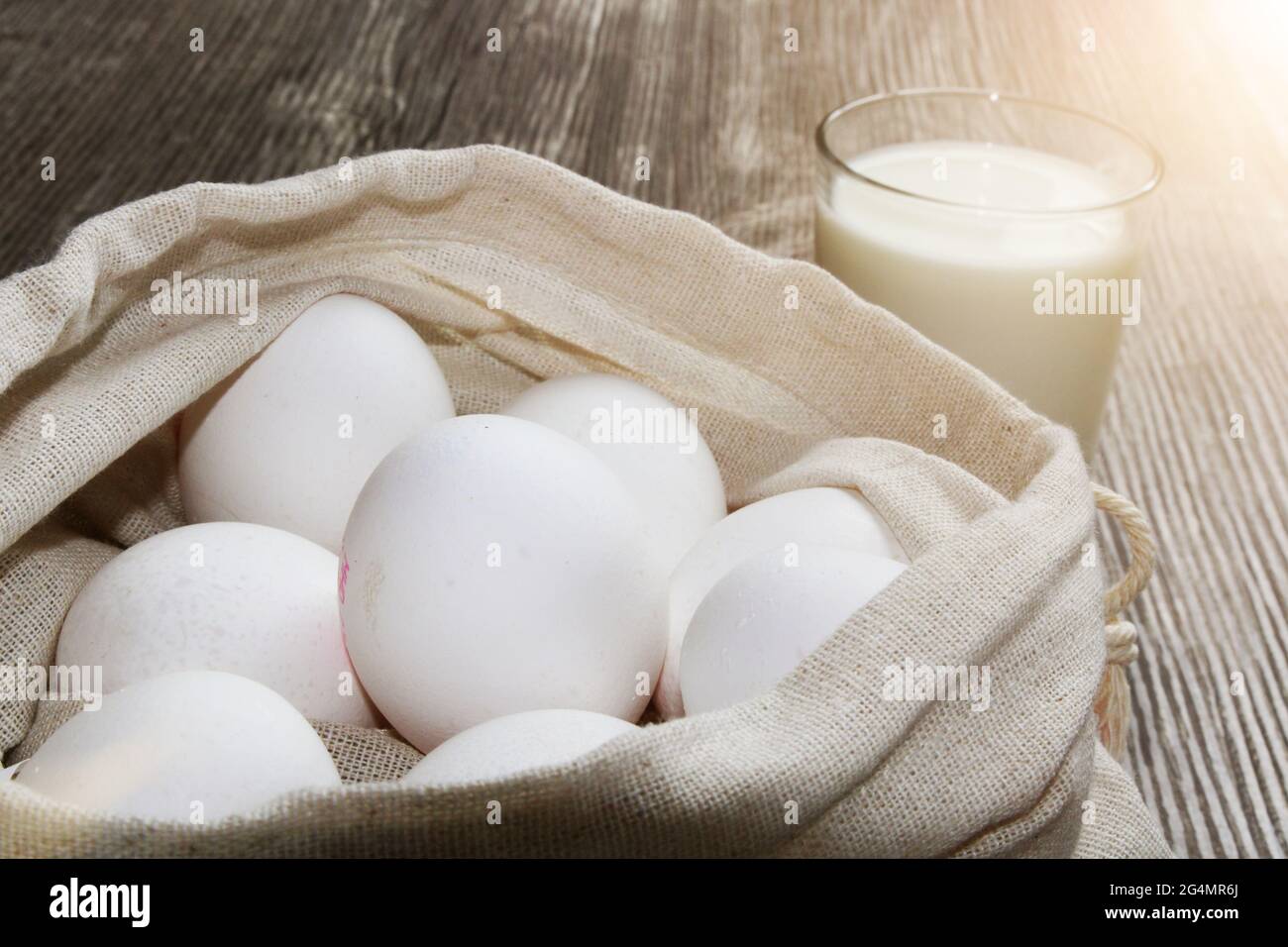 Symbolic image of baking ingredients: Eggs in a fabric bag Stock Photo ...