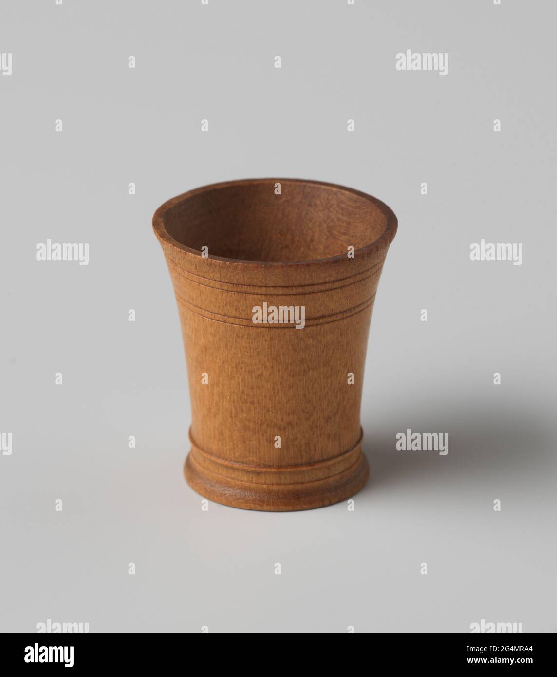 Cup with profile edge and two groove edges, turned. A cup of turned ...