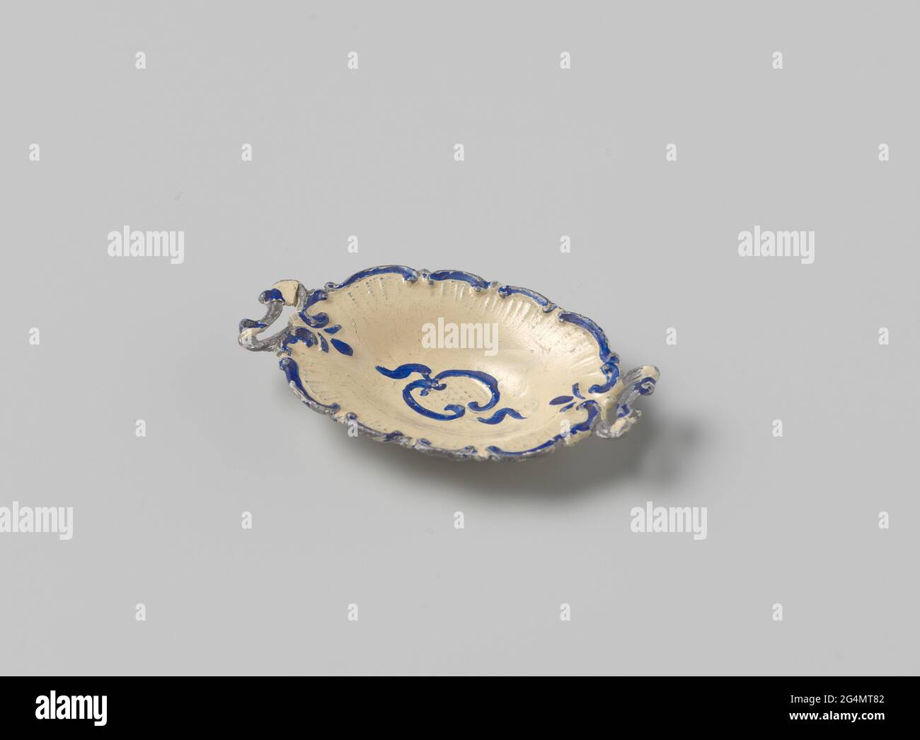 Miniature scale. Miniature shell decorated with blue curly motifs Stock ...