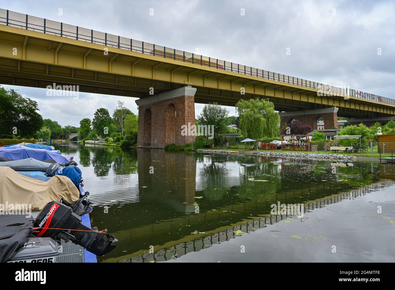 22 June 2021, Brandenburg, Rüdersdorf: The water of a canal reflects ...
