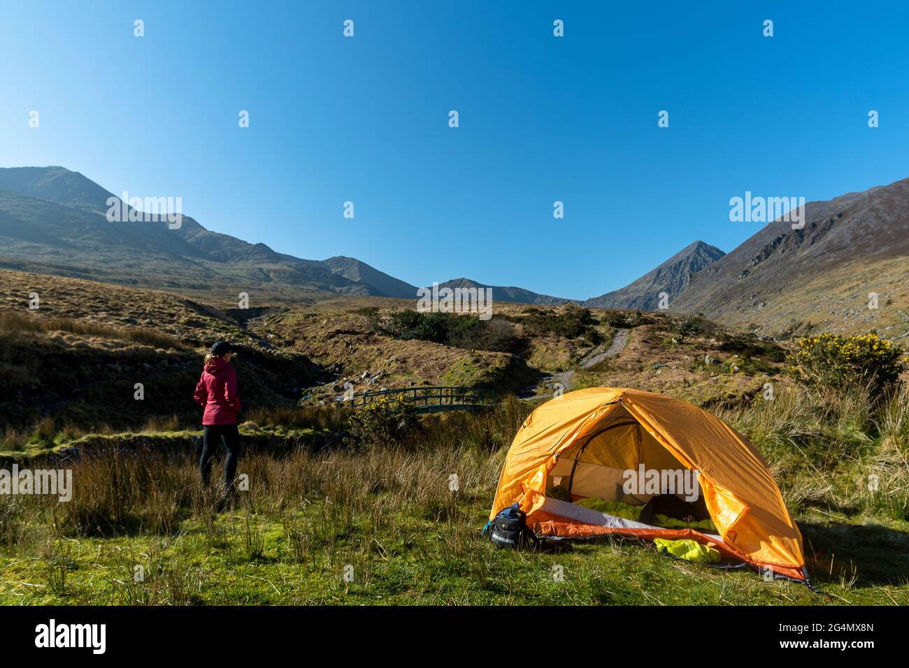 A happy woman on top of devils ladder with two lakes in the background ...