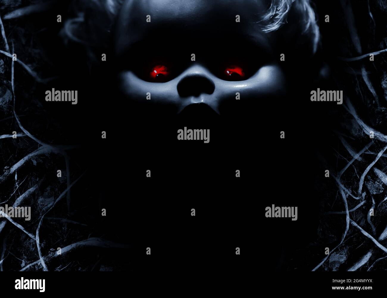 Creepy horror photo of old fashioned doll face with red eyes backdrop ...