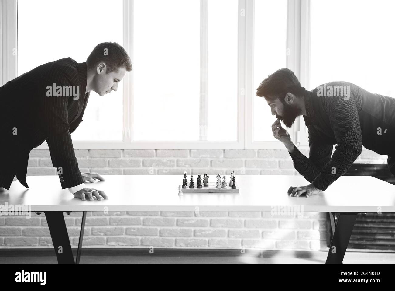 two male businessmen, rivals are playing chess. Strategy and rivalry ...