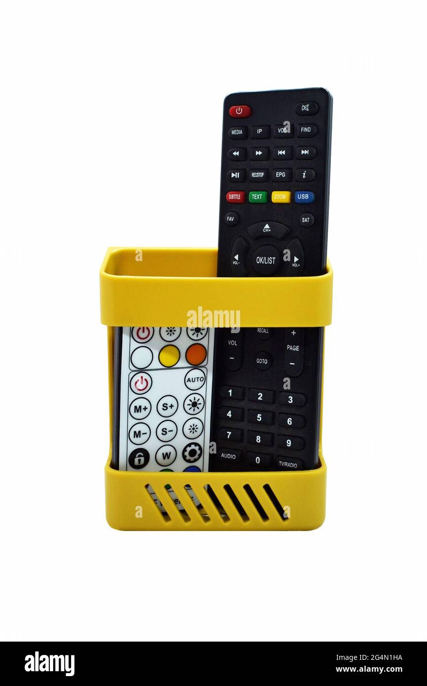 Wall mounted plastic organizer rack with different remote controls in ...