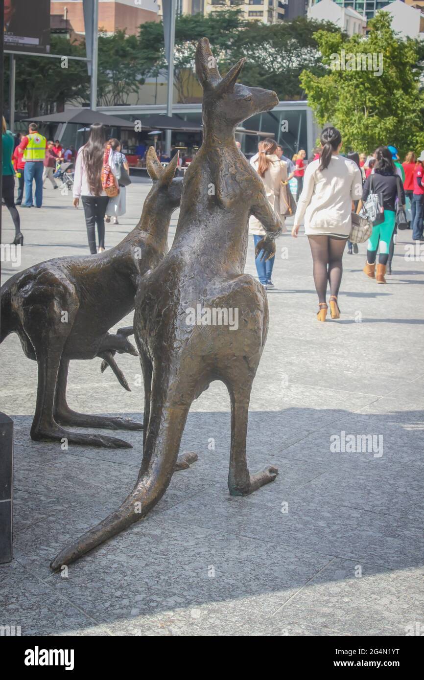 July 9 2014 Brisbane Australia - Crowd walks away with statues of ...