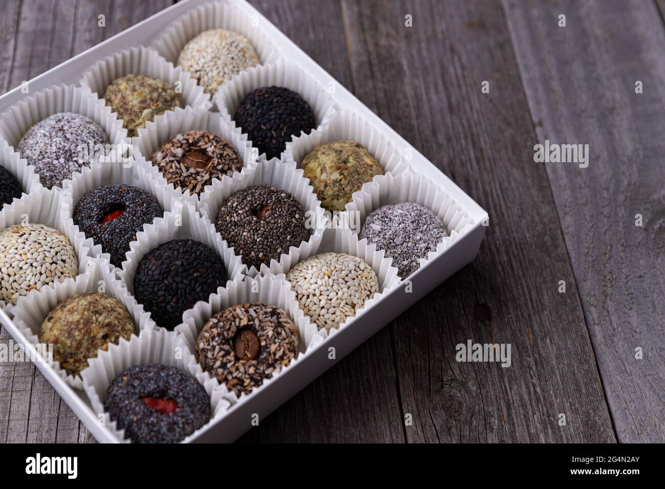 Box of vegan sweets energy balls on wooden table Stock Photo - Alamy