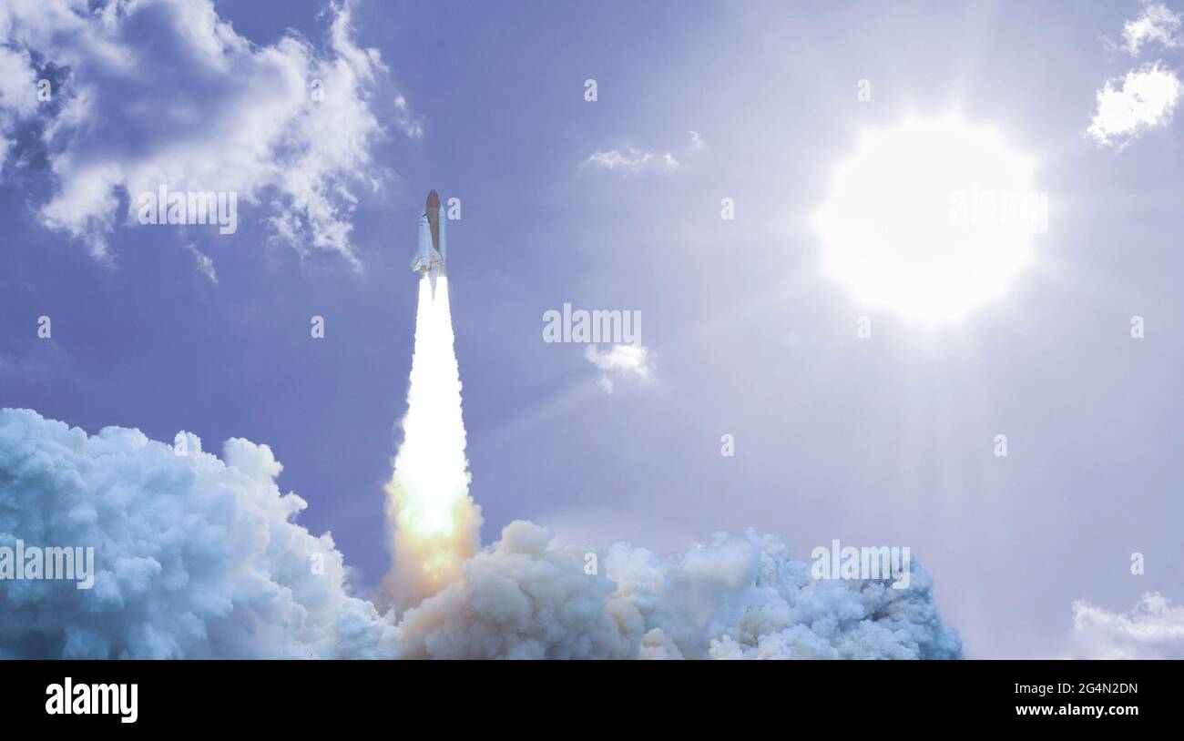 the spaceship rocket shuttle in the cloudy sky fly up high to the space ...