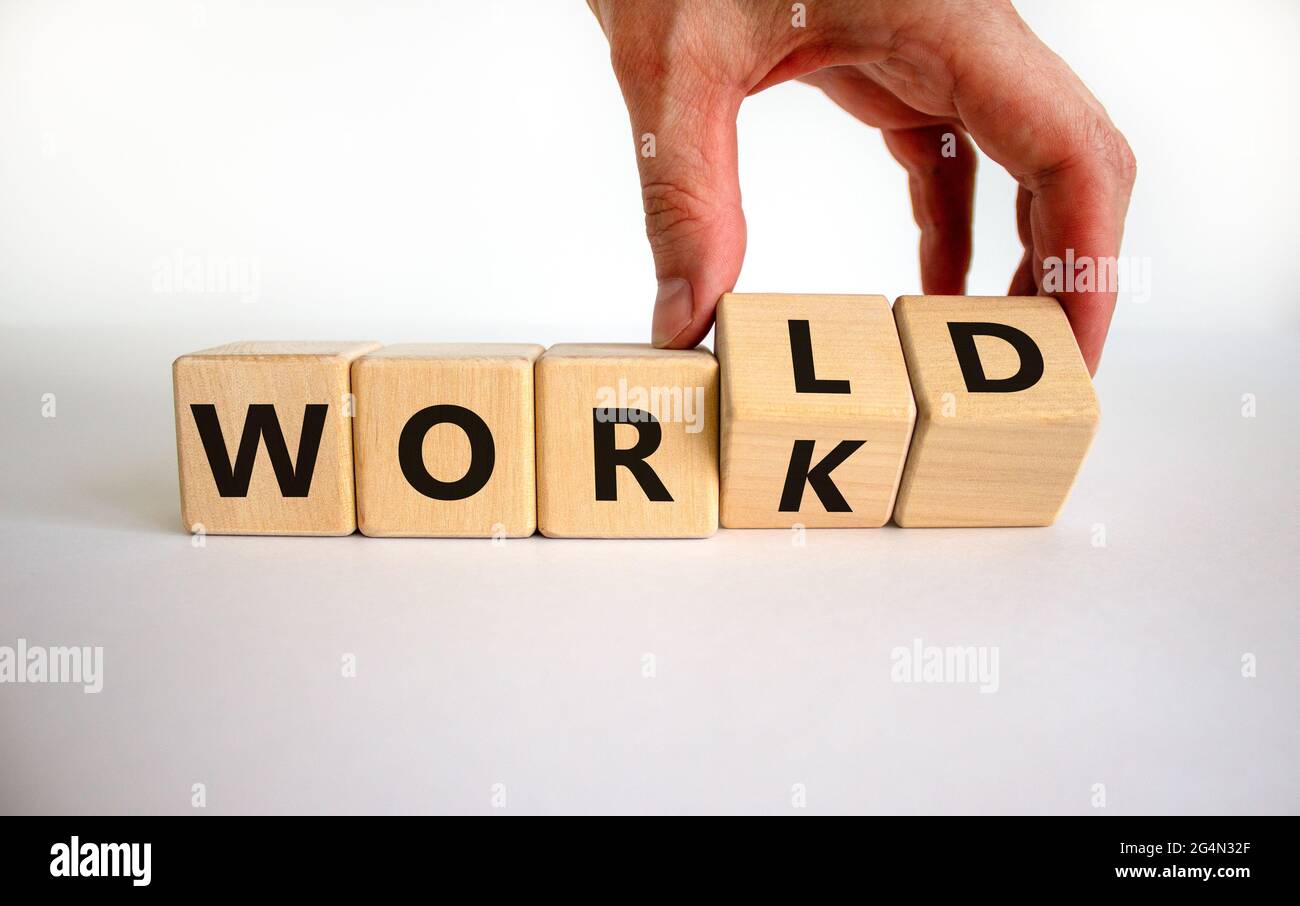 World and work symbol. Businessman turns wooden cubes and changes the ...
